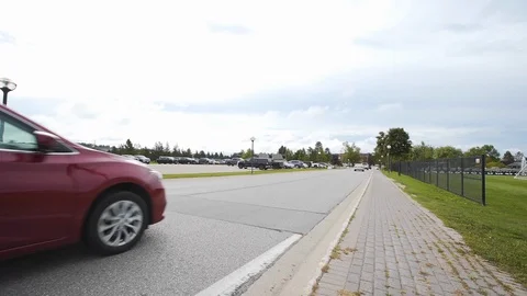 Red car driving into a parking lot at a ... | Stock Video | Pond5