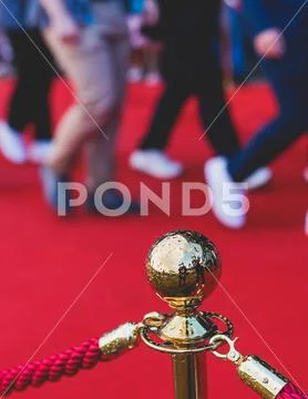 Photograph: Red carpet with ropes and golden barriers on a luxury party ...