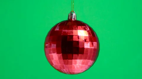 A red checkered ball is spinning on a gr... | Stock Video | Pond5