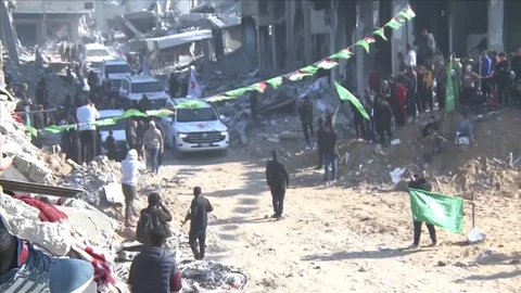 Red Cross vehicles arrive at hostage han... | Stock Video | Pond5