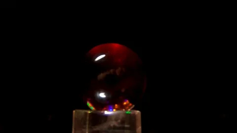 Red crystal ball rotating in the dark wi... | Stock Video | Pond5