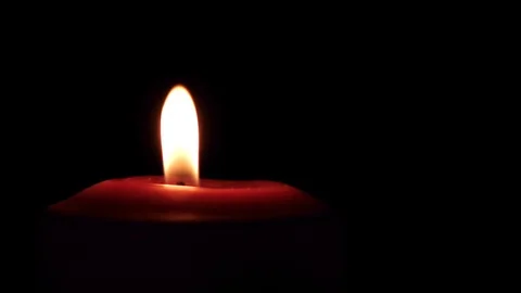 a red dimly lit candle rotates 360 degre... | Stock Video | Pond5
