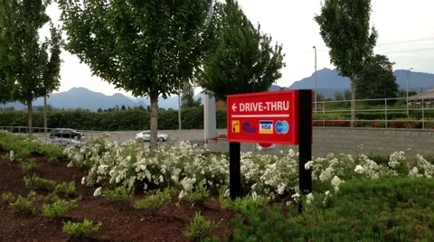 Red drive-thru sign with traffic flow ba... | Stock Video | Pond5