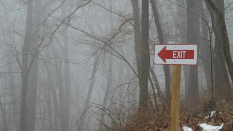 Red exit arrow sign in front of haunted ... | Stock Video | Pond5