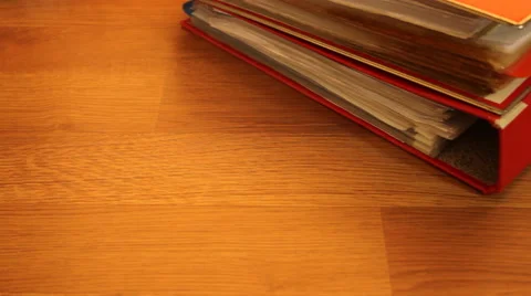 Red file folders, ring binders on office... | Stock Video | Pond5