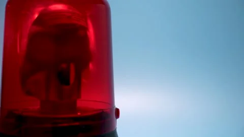 Red flashing light on a blue background. | Stock Video | Pond5