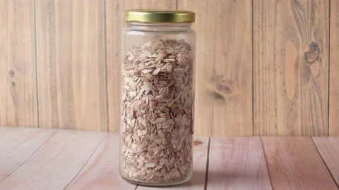 red Flattened rice in a jar on table | Stock Video | Pond5