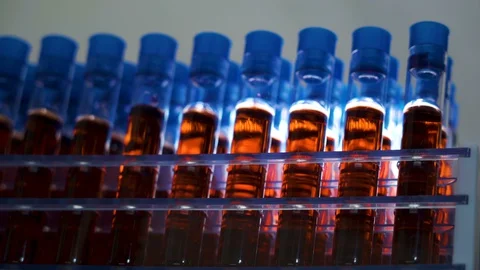 The red fluids inside the test tubes on ... | Stock Video | Pond5