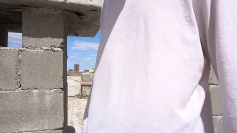 Red-haired young man standing on the roo... | Stock Video | Pond5