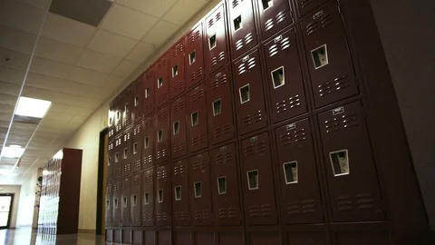 Red high school lockers, narrow hallway. | Stock Video | Pond5