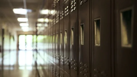 Red high school lockers, narrow hallway. | Stock Video | Pond5