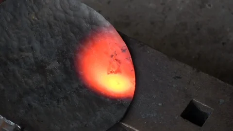 A red-hot metal disk resembling a small ... | Stock Video | Pond5