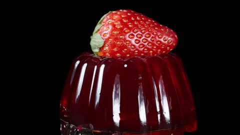 Red Jelly Rotates on a black background ... | Stock Video | Pond5