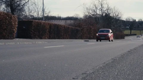 Red modern car driving on suburbs street... | Stock Video | Pond5