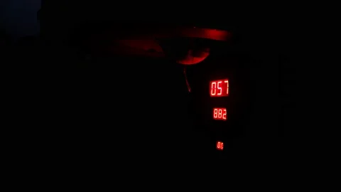 Red numbers on the display in the dark, ... | Stock Video | Pond5