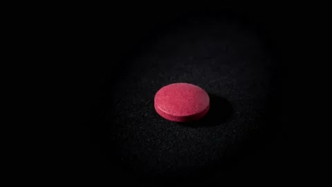 Red pill on black background | Stock Video | Pond5