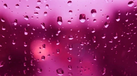 Red pink Rain drops on window glass ,rai... | Stock Video | Pond5