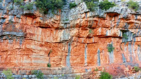 Red rugged cliff - sedimentary rock moun... | Stock Video | Pond5