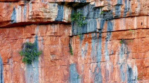 Red rugged cliff - sedimentary rock moun... | Stock Video | Pond5