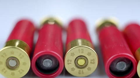 Red shotgun shells on a light surface. | Stock Video | Pond5