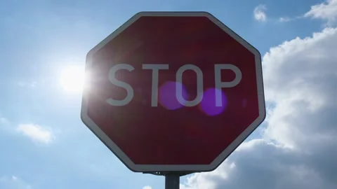 Red stop sign on metal pole on street. R... | Stock Video | Pond5