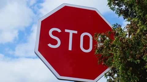 Red stop sign on metal pole on street. R... | Stock Video | Pond5