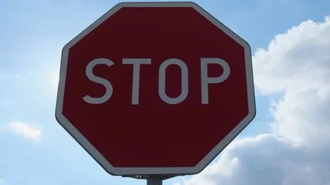 Red stop sign on metal pole on street. R... | Stock Video | Pond5