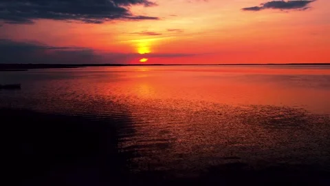 Red sunset by the lake. Hot weather at s... | Stock Video | Pond5