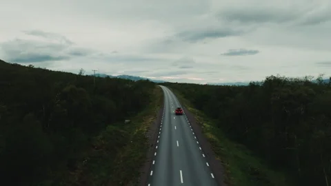 Red SUV car driving alone up the empty d... | Stock Video | Pond5