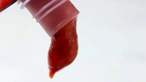 Red tomato ketchup pouring from a tube c... | Stock Video | Pond5