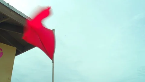 Red warning hazard flag on the beach dur... | Stock Video | Pond5
