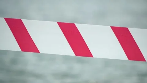 Red white warning tape barrier ribbon sw... | Stock Video | Pond5