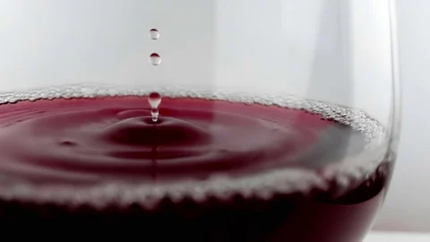 red wine drop falling down into drink gl... | Stock Video | Pond5