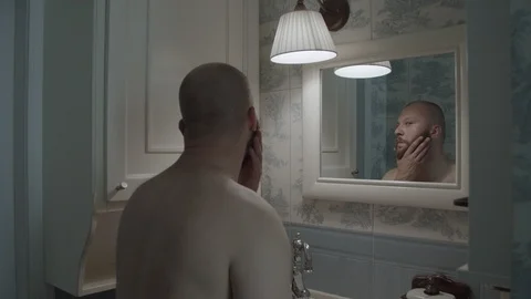 Reflection in the mirror of shaved head ... | Stock Video | Pond5