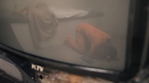 Reflection in TV screen in prison cell o... | Stock Video | Pond5