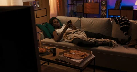 Relaxed guy is lying on the couch in the... | Stock Video | Pond5