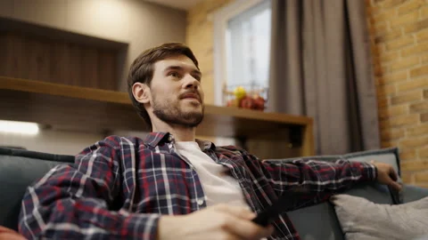 Relaxed man watching TV at home alone, l... | Stock Video | Pond5