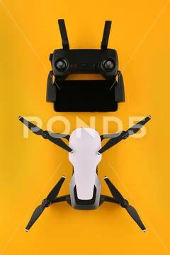 Remote control drone top view on yellow background ~ Hi Res #113828968
