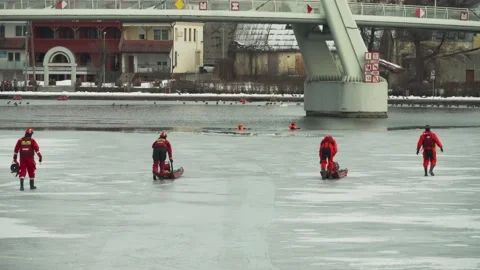 Rescuers Pushing Ice Rescue Boards On Fr... | Stock Video | Pond5