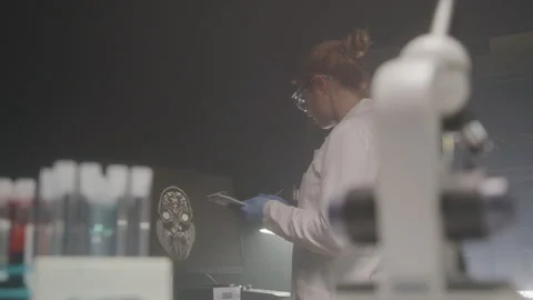 Research Scientist in Lab Coat Analyzes ... | Stock Video | Pond5