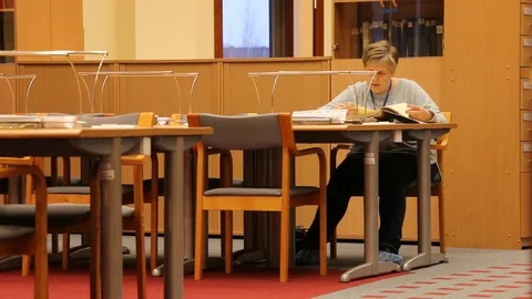 Researcher reading books in library | Stock Video | Pond5