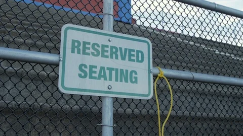 Researved seating sign on fence with ble... | Stock Video | Pond5