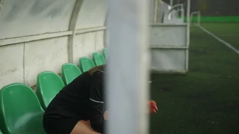 Reserve woman football player sitting on... | Stock Video | Pond5