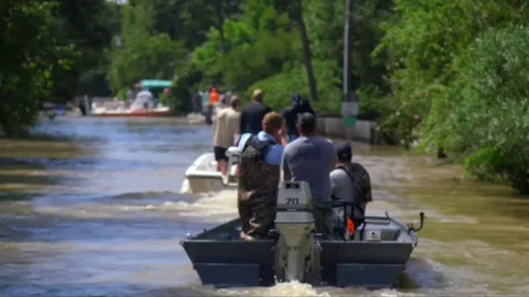 Residents evacuated by boat, helicopter ... | Stock Video | Pond5