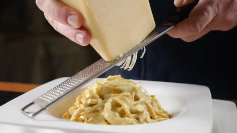 Restaurant food cooking. Chef grating ch... | Stock Video | Pond5