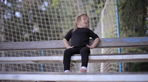 Restless Little Girl in a Black Suit Sit... | Stock Video | Pond5