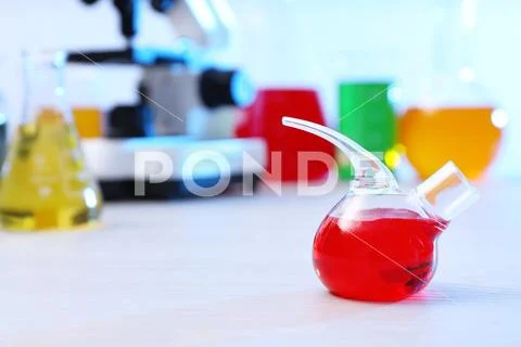 Retort flask with sample on table in chemistry laboratory, space for ...