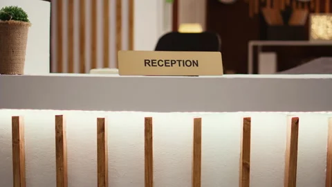 Reveal of reception sign in hotel lobby | Stock Video | Pond5