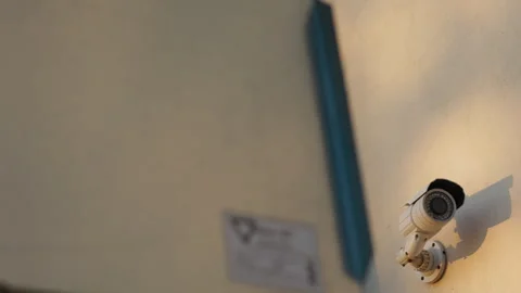 Revealing shot of a wall-mounted CCTV ca... | Stock Video | Pond5