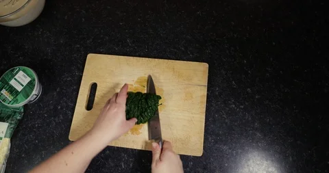 Reverse Clip Of Lady Cutting Spinach Usi... | Stock Video | Pond5